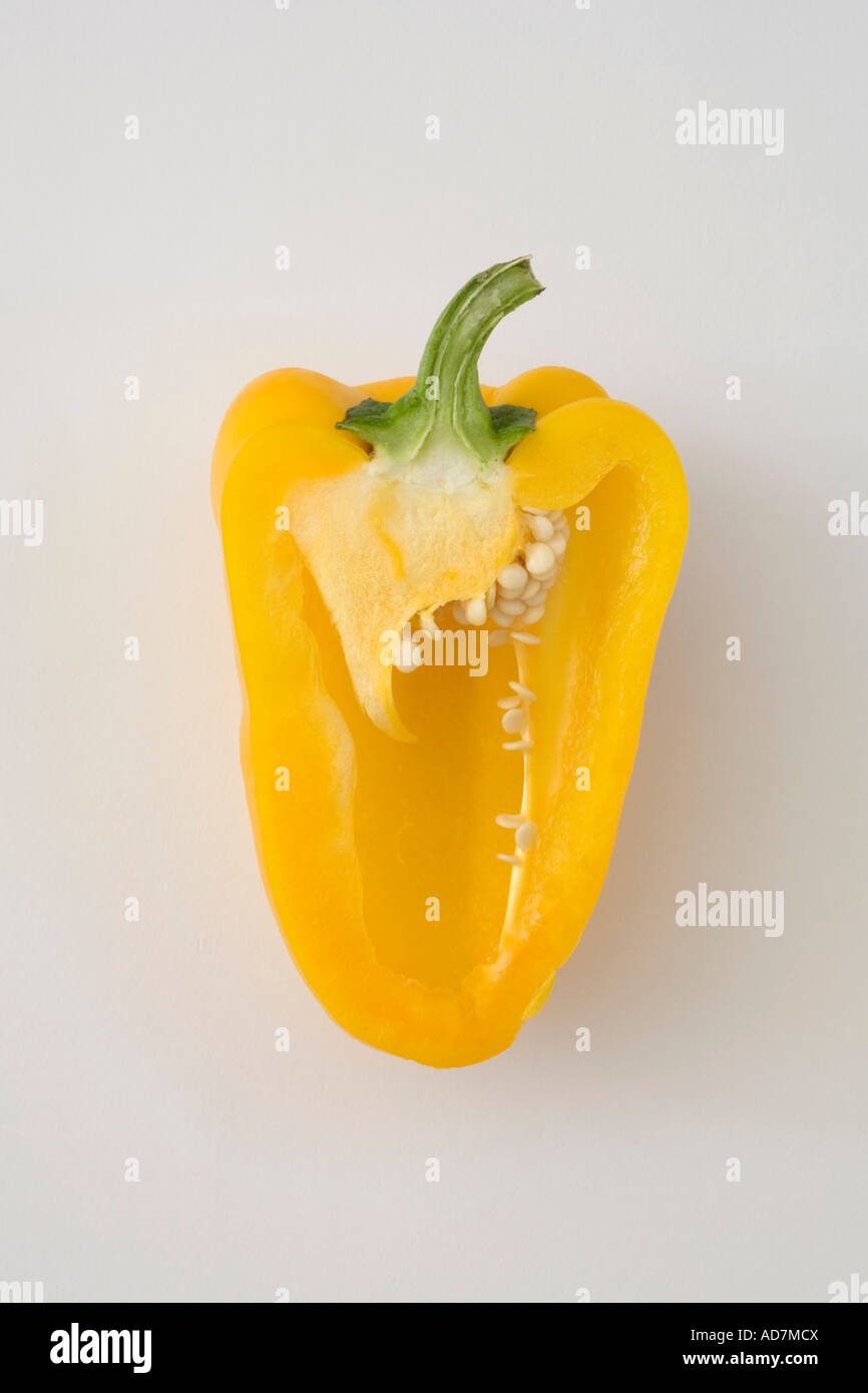 Single halved yellow pepper on white background Stock Photo - Alamy