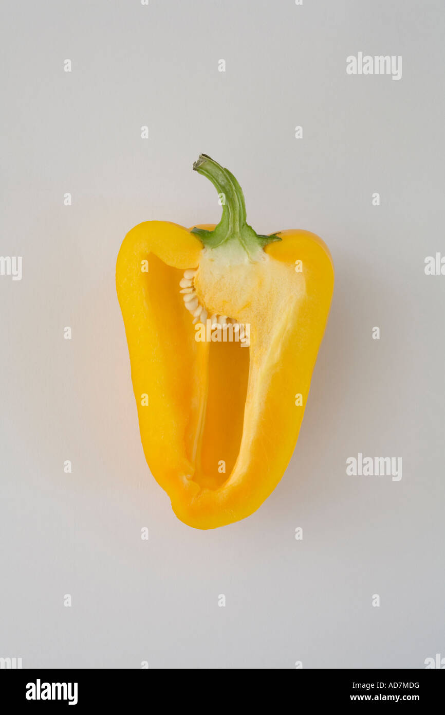 Single halved yellow pepper against pale grey background Stock Photo ...