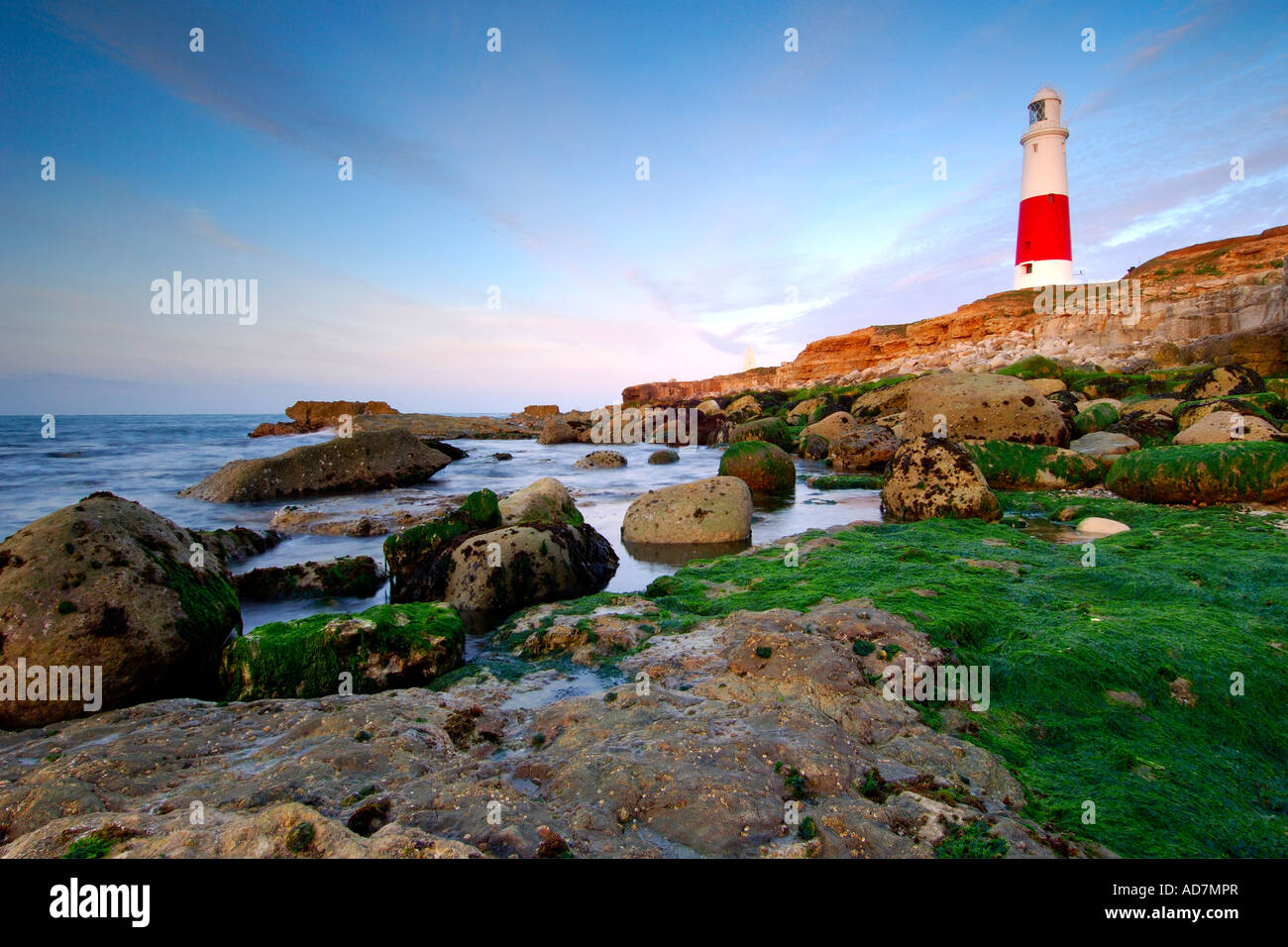 Portland Bill lighthouse at dawn taken from the foreshore amongst the ...