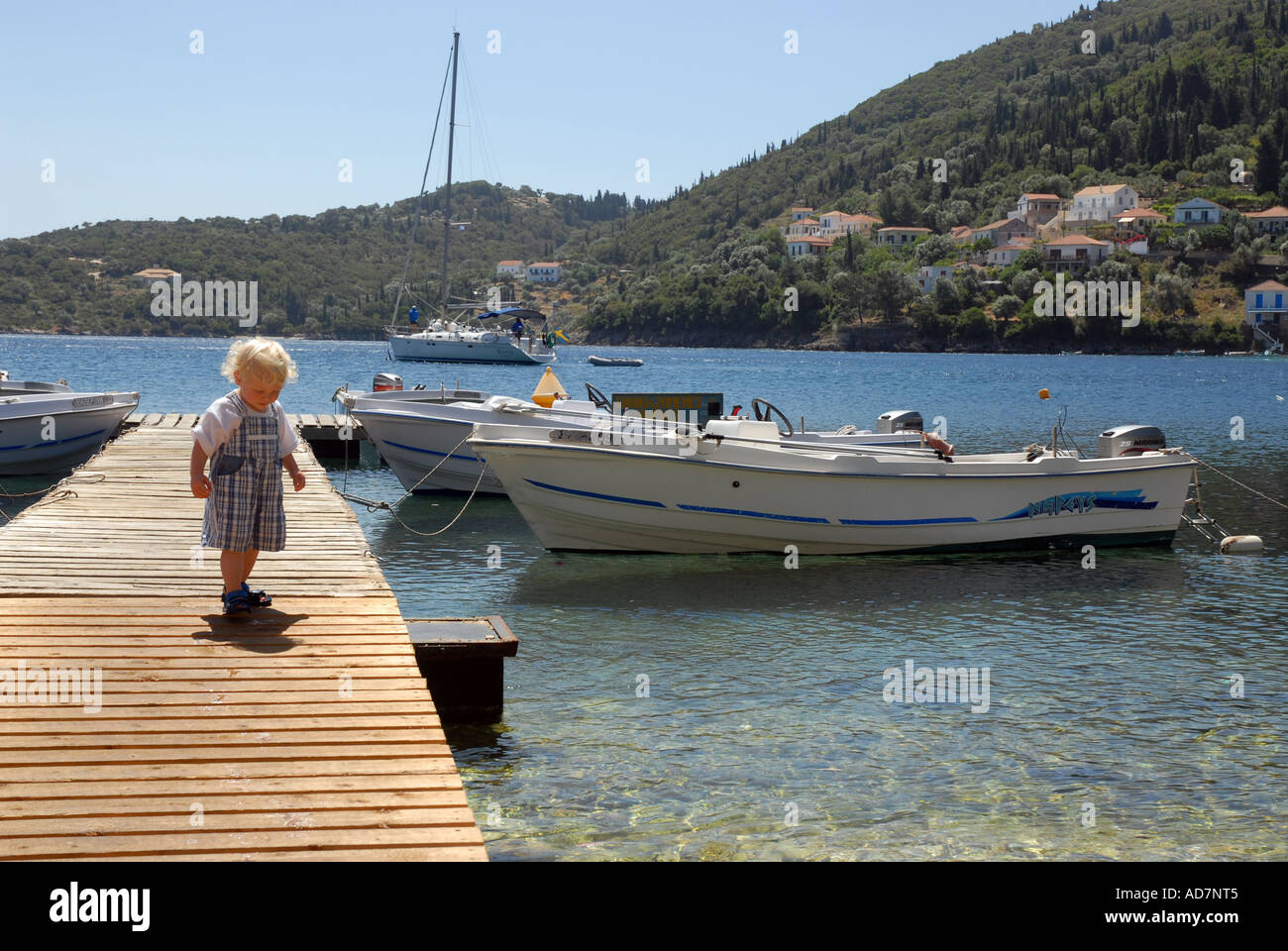 Wilf on jetty at Kioni harbour, Ithaca Island, Greece Stock Photo - Alamy