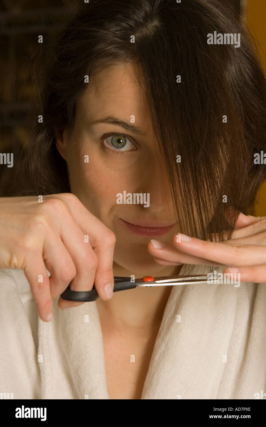 Woman cutting hair Stock Photo - Alamy