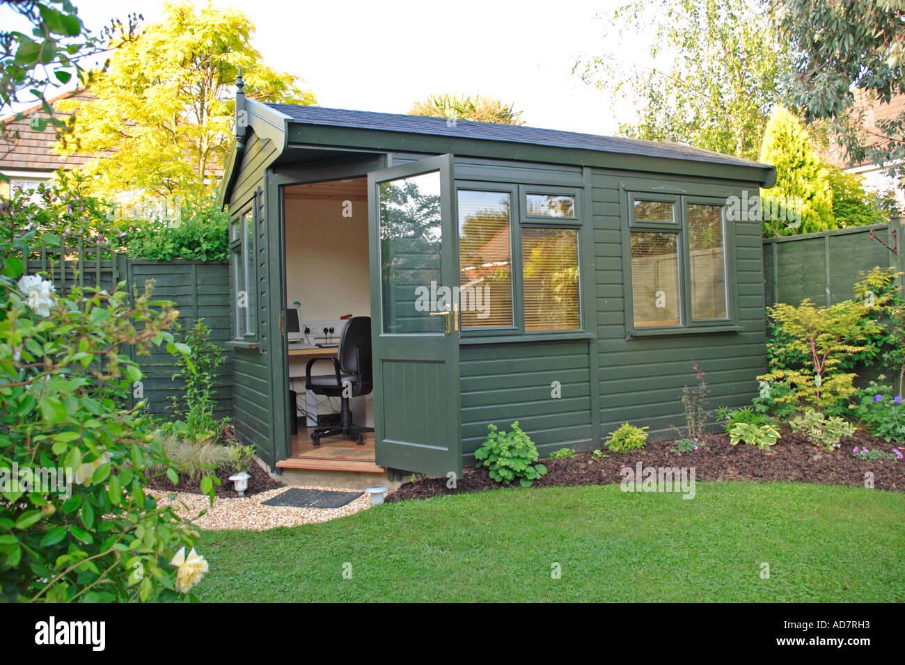 Green timber office installed in suburban garden Stock Photo - Alamy