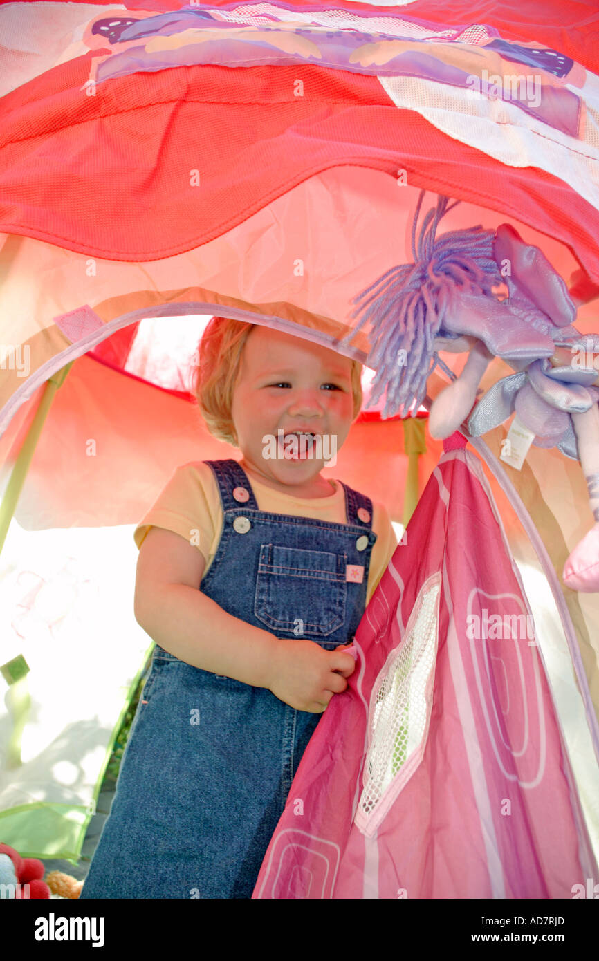Toddler playing and laughing in pink play tent Stock Photo - Alamy