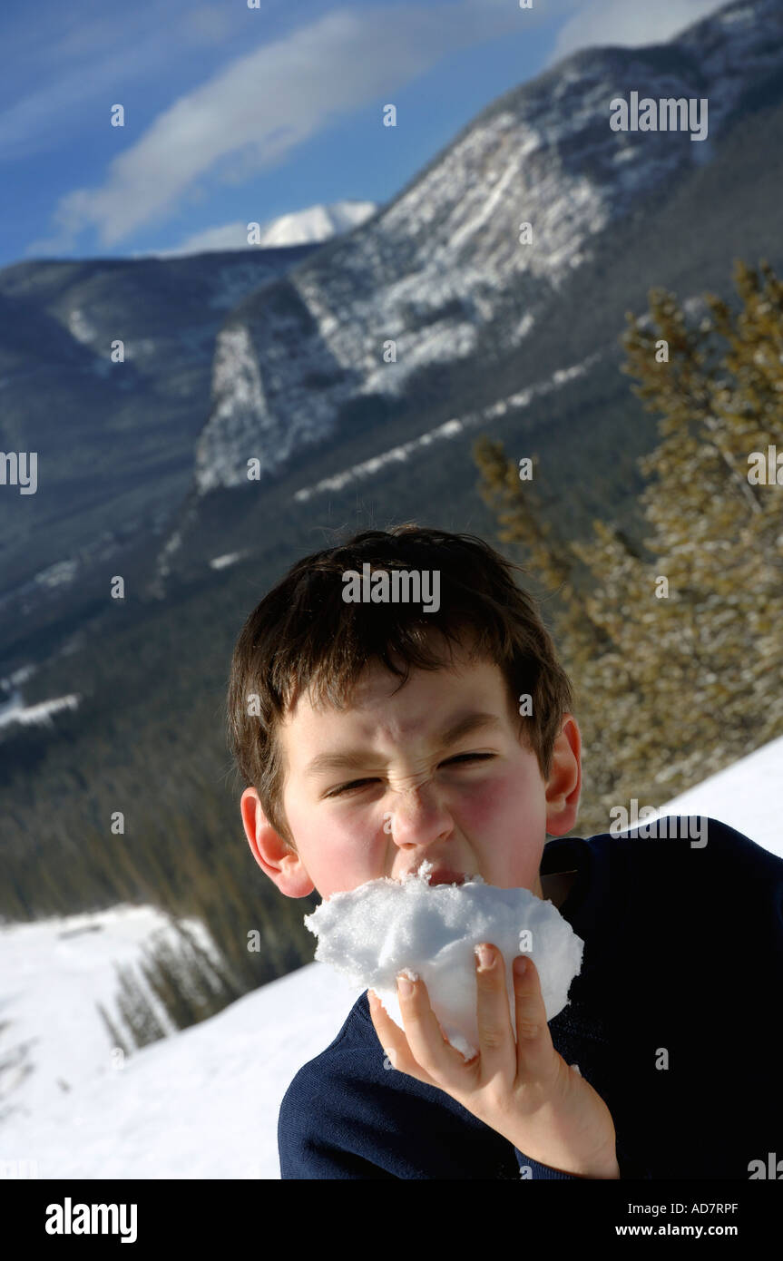 Boy eating snow Stock Photo - Alamy
