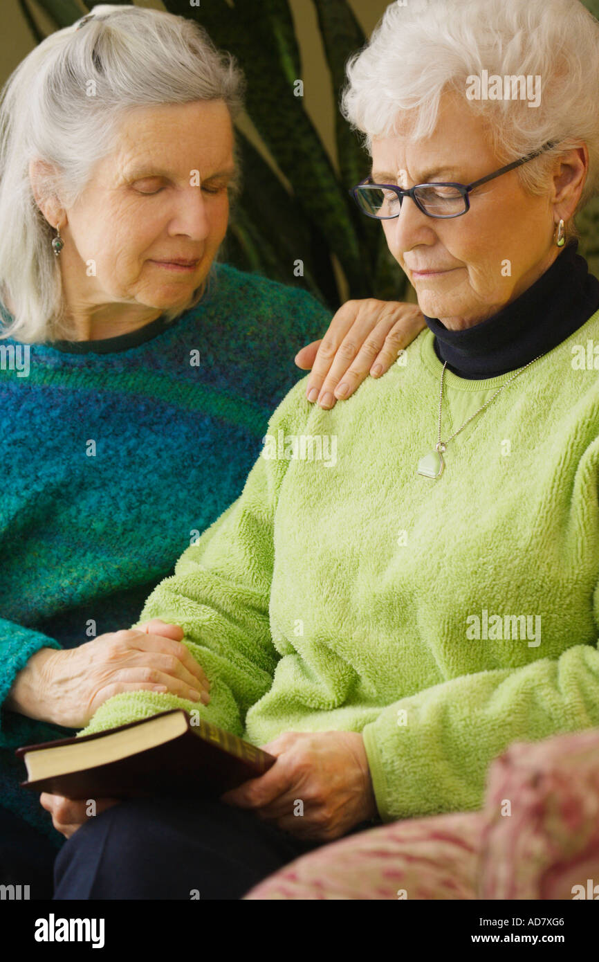 Two women in prayer Stock Photo - Alamy