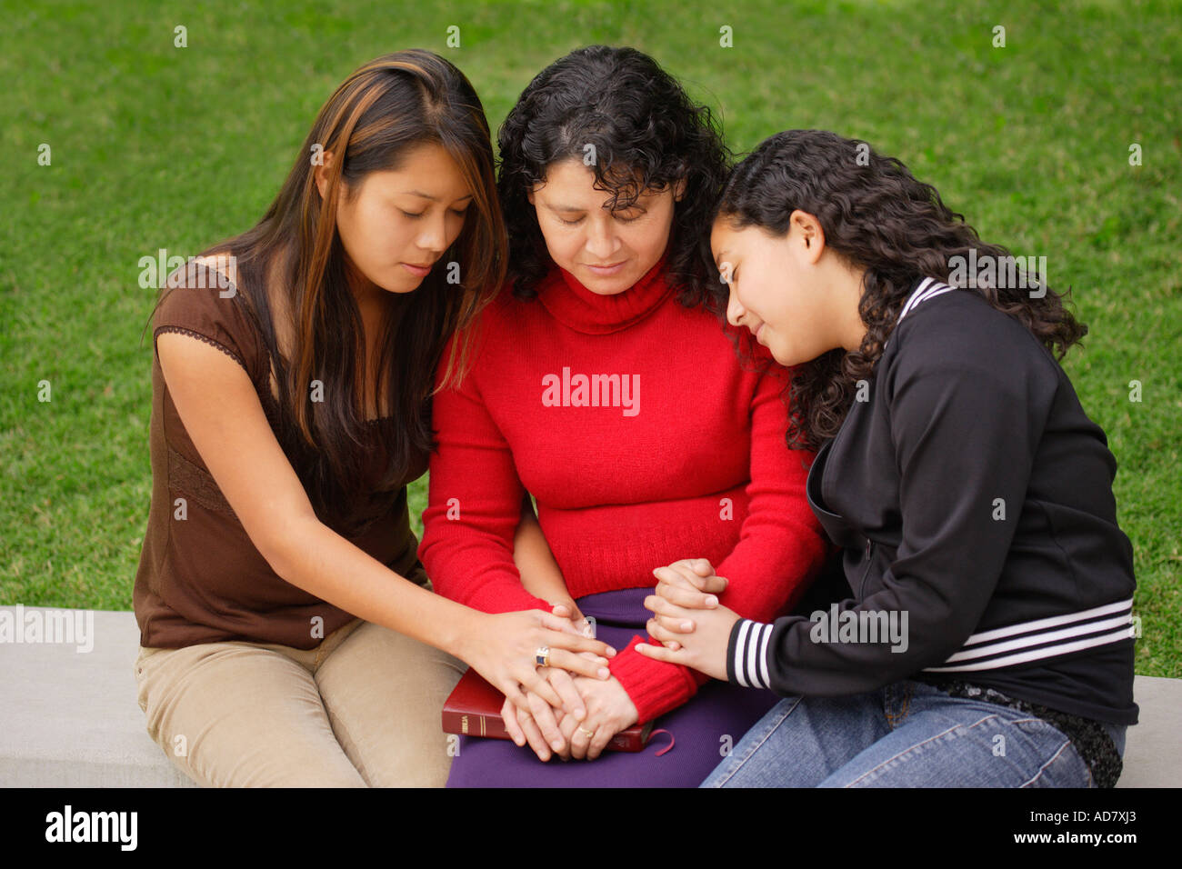 Mother praying with daughters hi-res stock photography and images - Alamy