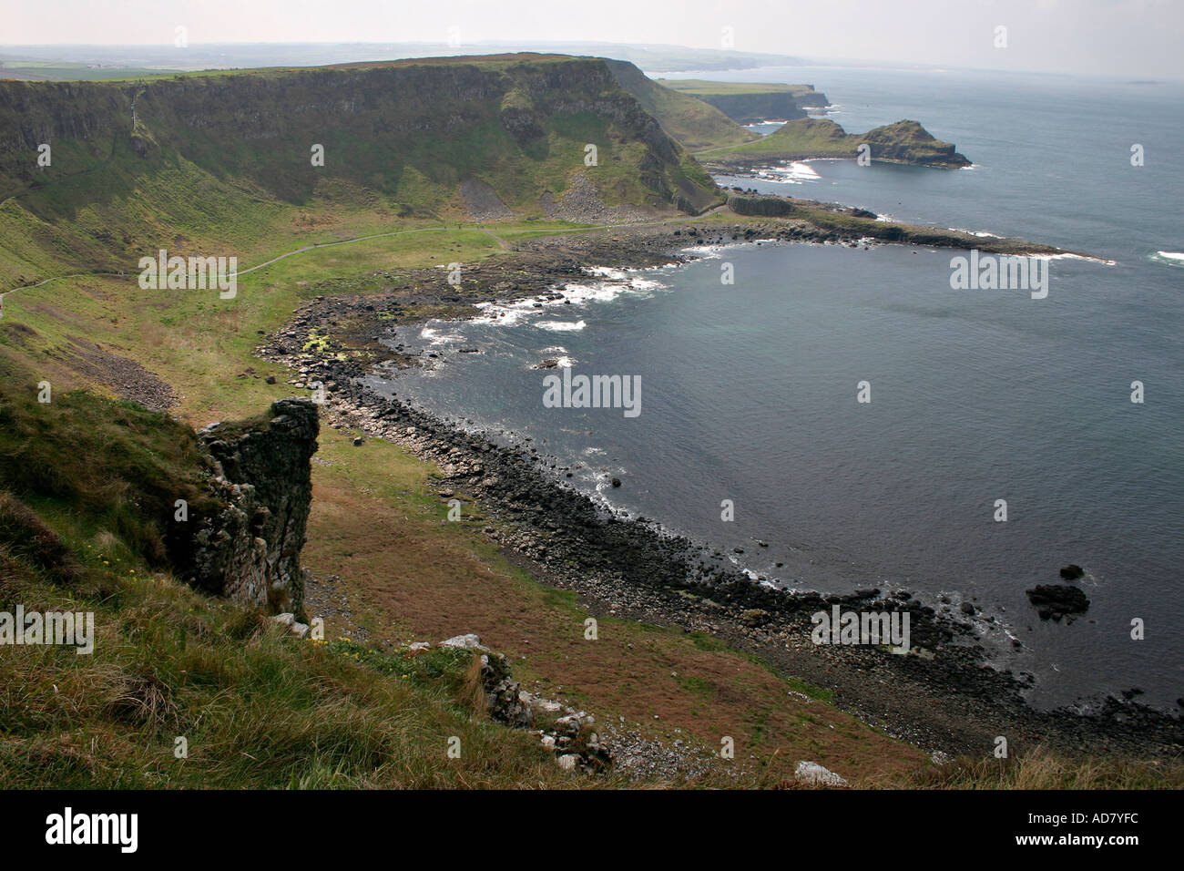 The view from the Causeway Coast Way path of the inlet and headland to ...