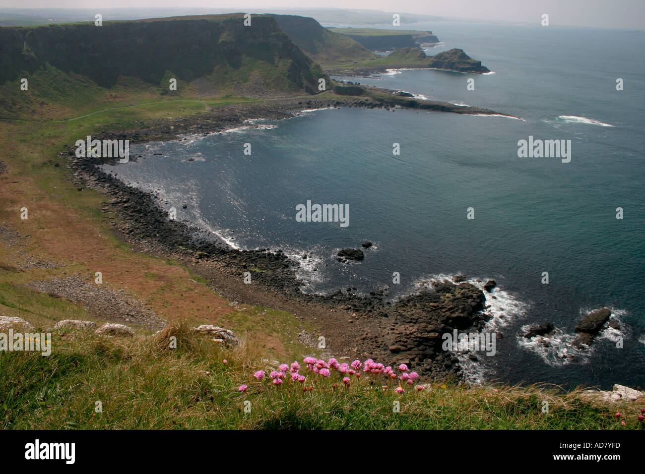 The view from the Causeway Coast Way path of the blue water of the ...