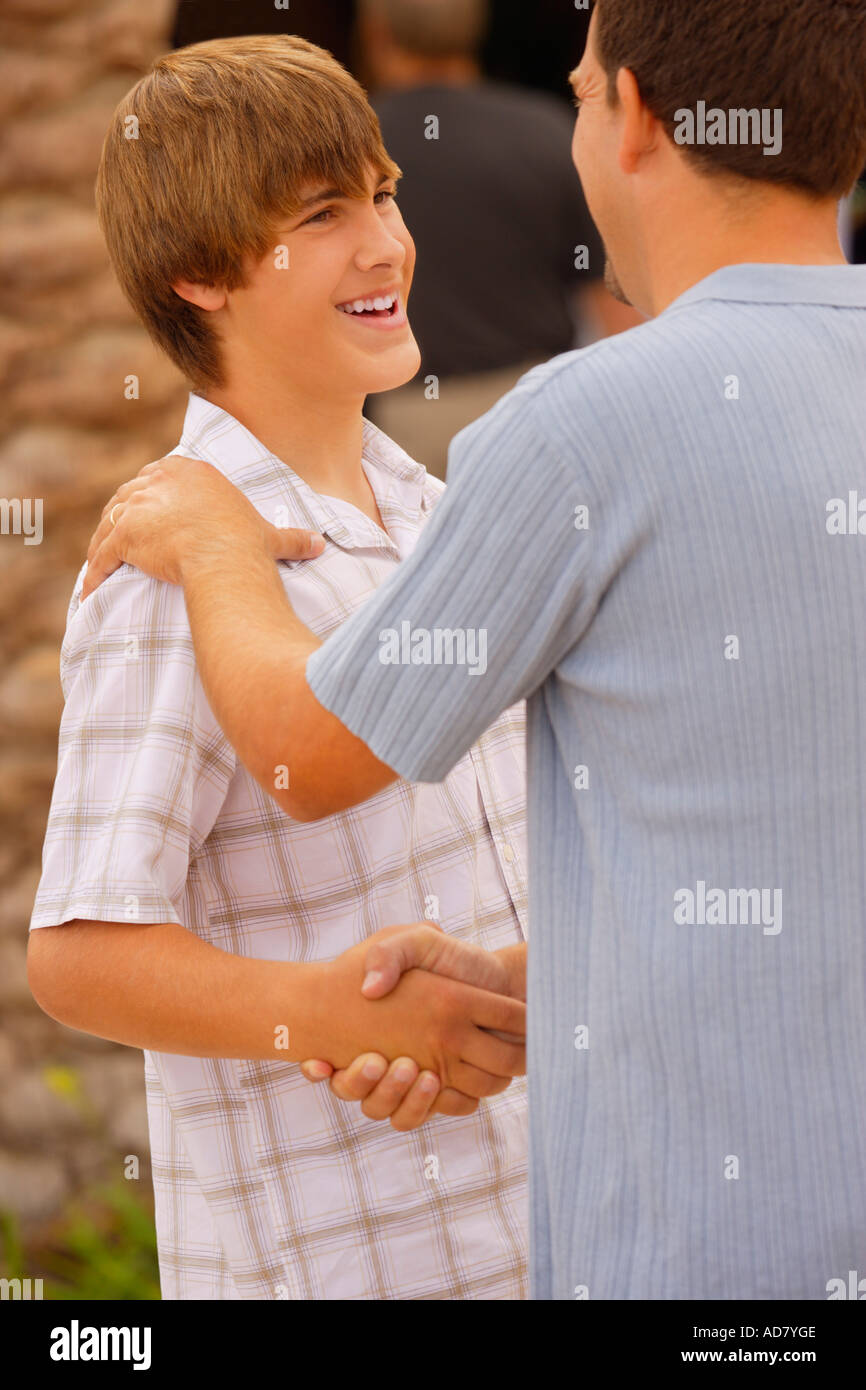 Adult shaking hands with kid hi-res stock photography and images - Alamy