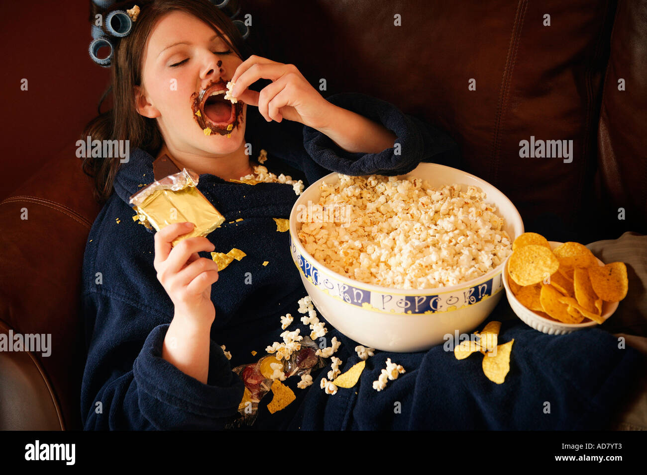 Woman eating junk food Stock Photo - Alamy