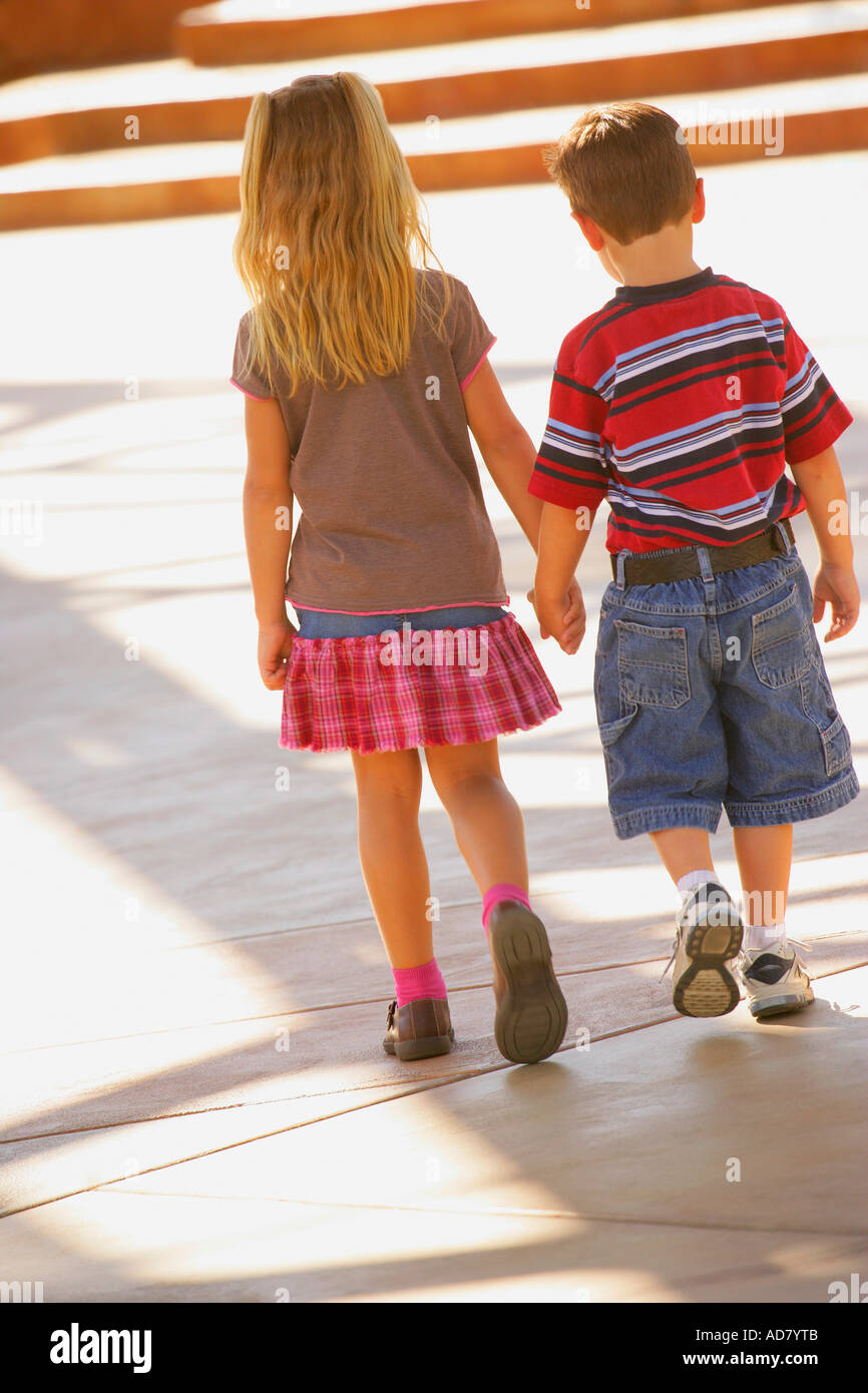 Two kids holding hands Stock Photo - Alamy