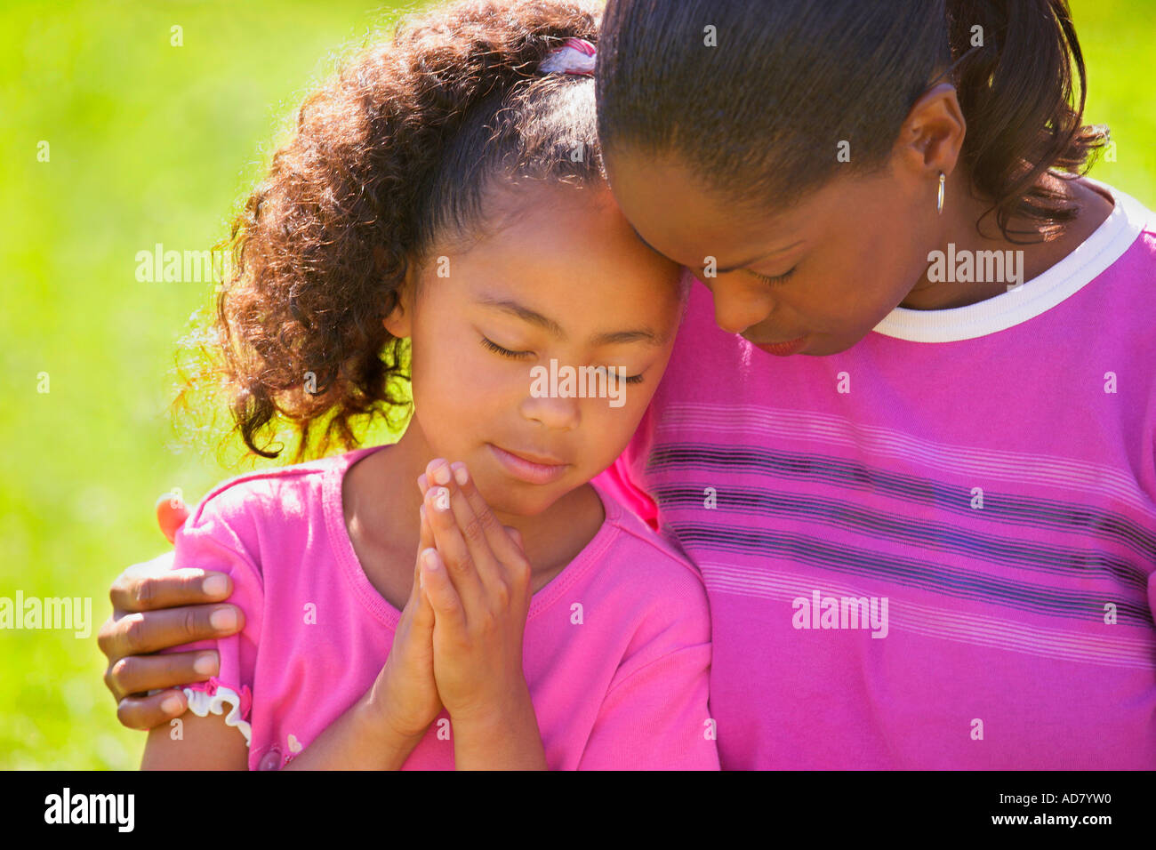 Mother praying with daughters hi-res stock photography and images - Alamy
