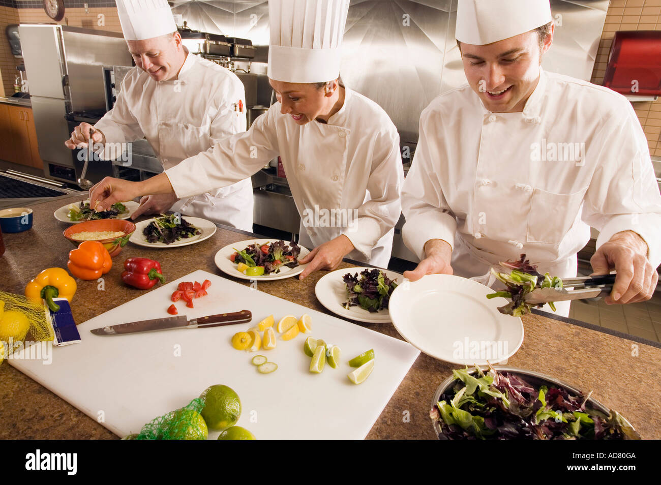 Chef s assembling food in a kitchen Stock Photo - Alamy