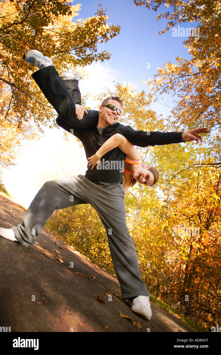 Man holds woman over his shoulder Stock Photo - Alamy