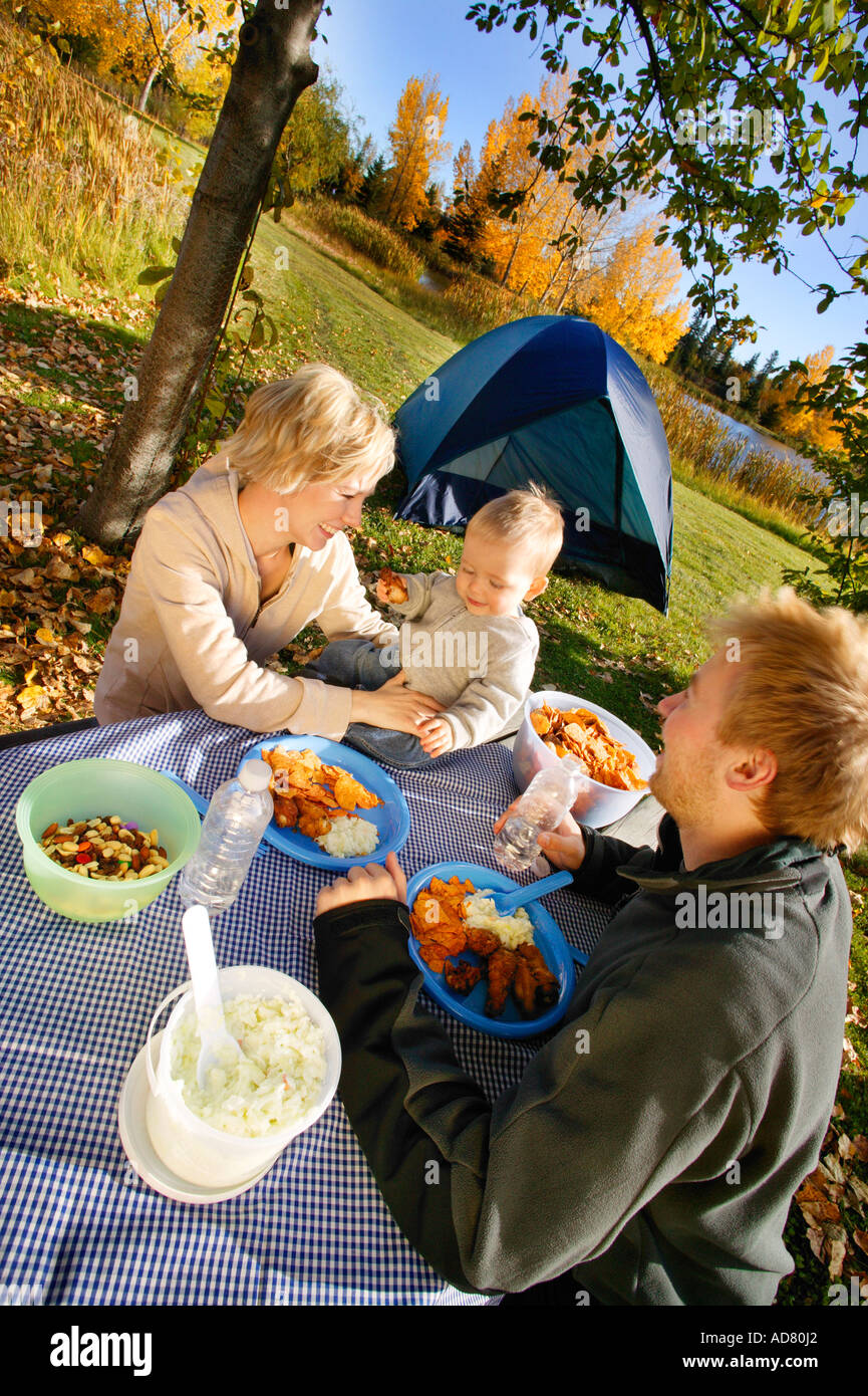 Young family camping Stock Photo - Alamy