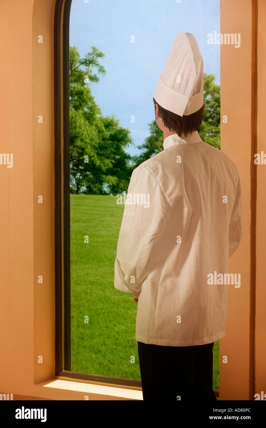 A chef looking outside a window Stock Photo - Alamy
