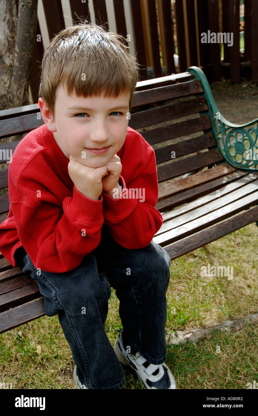 Boy on bench Stock Photo - Alamy
