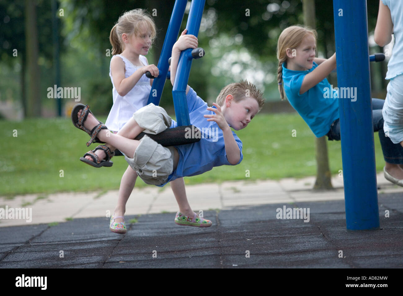 Children at a swing at the playground Stock Photo - Alamy
