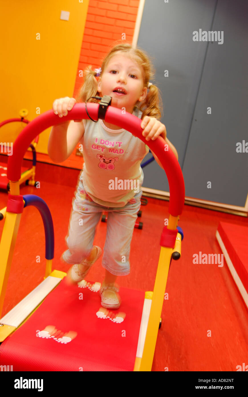 4 year old girl at a recreation centre using running machine in creche ...