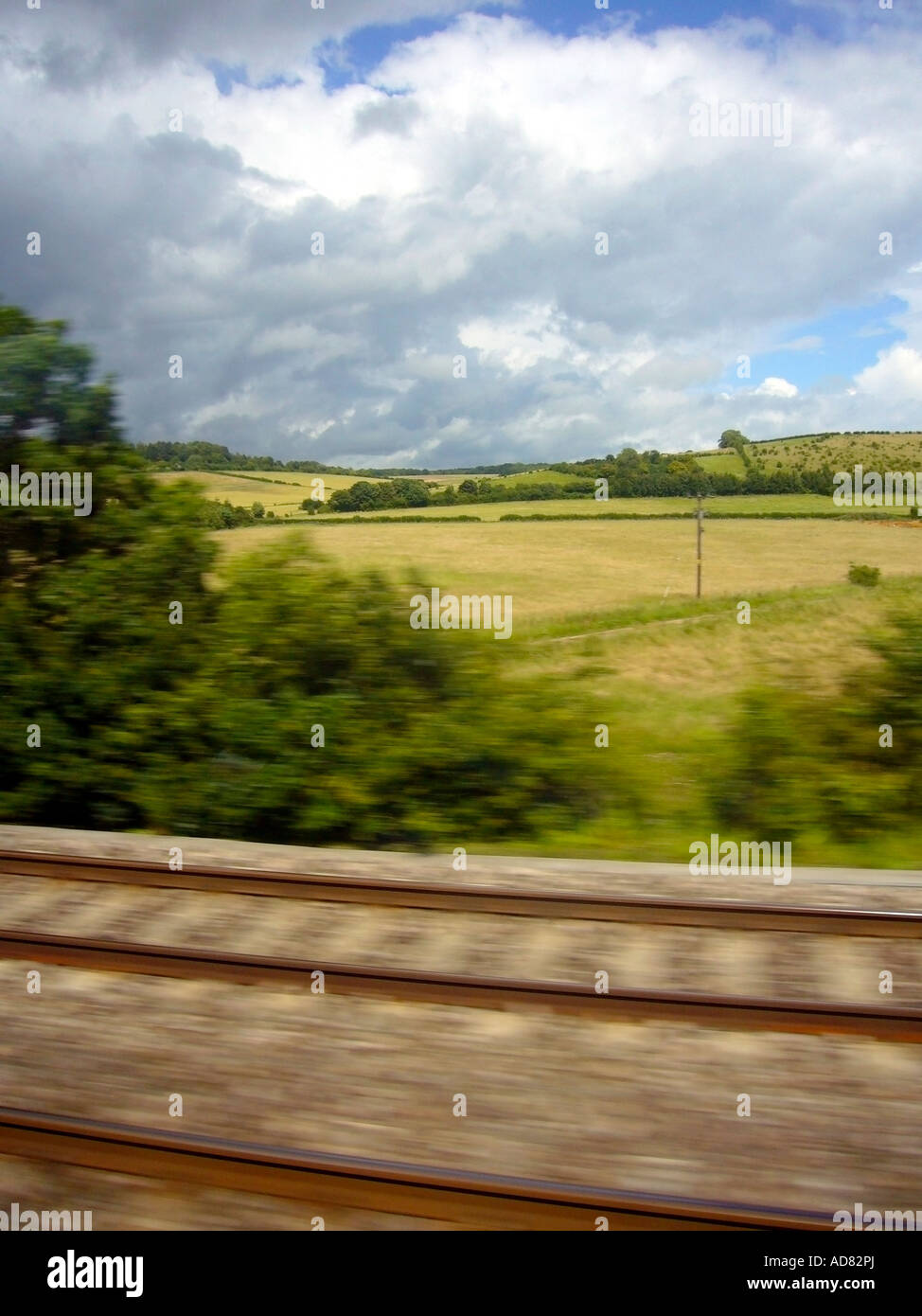 View from moving train in Oxfordshire countryside in the summer sun ...