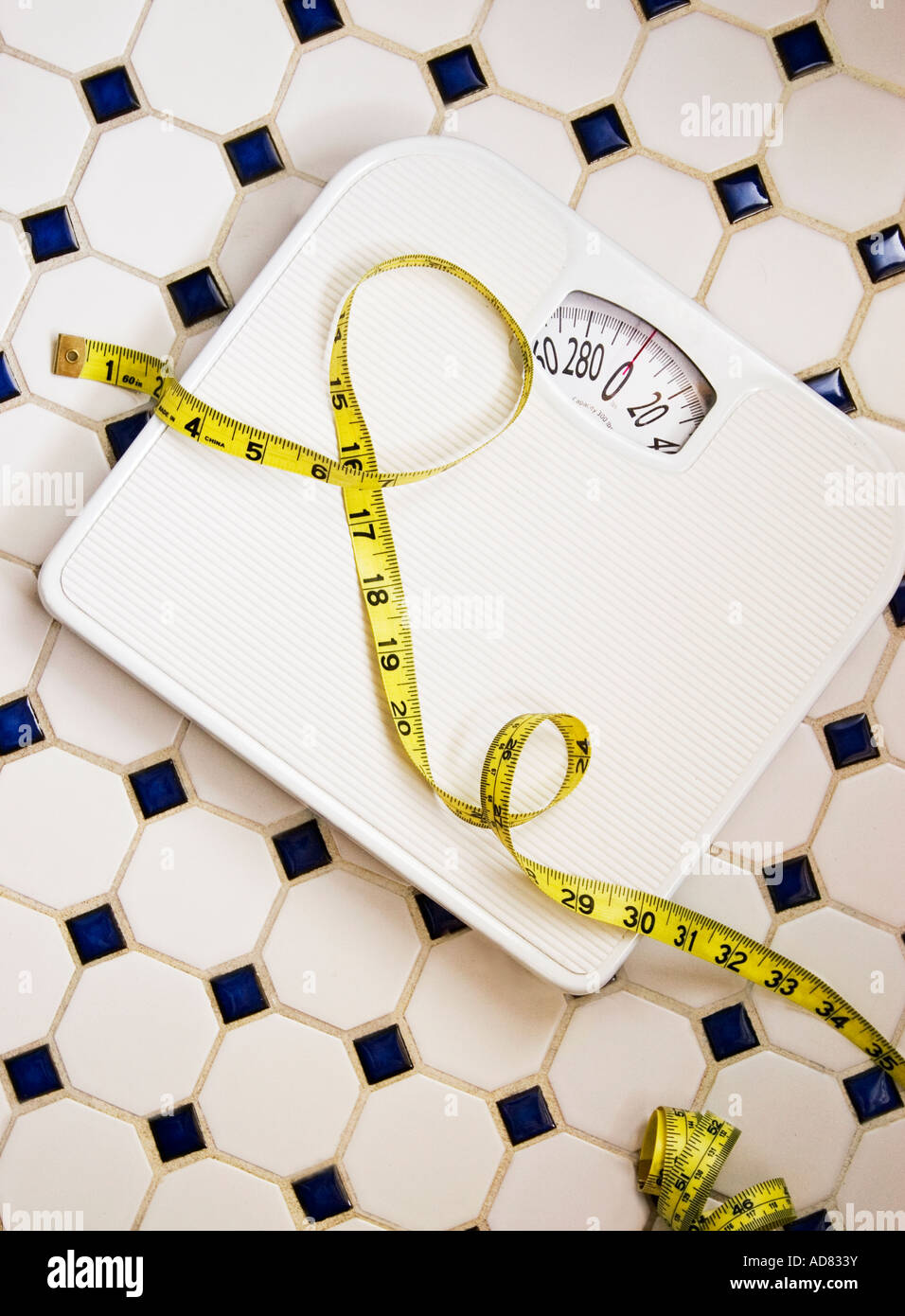 Tape measure and scale on a bathroom floor Stock Photo - Alamy