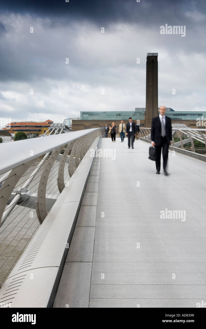 Lone Commuter walking across Millennium bridge into City of London ...