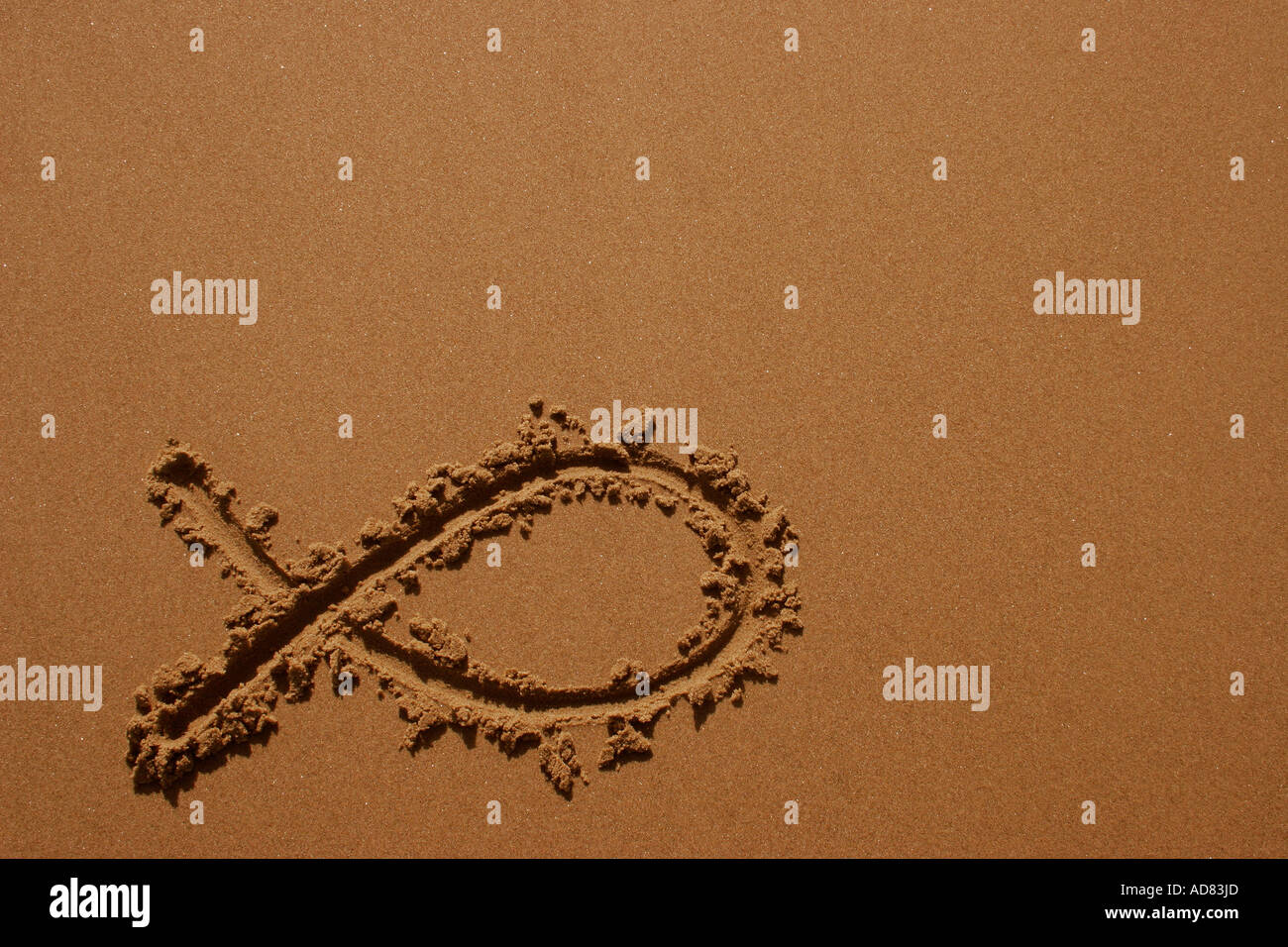 Fish symbol in sand Stock Photo - Alamy