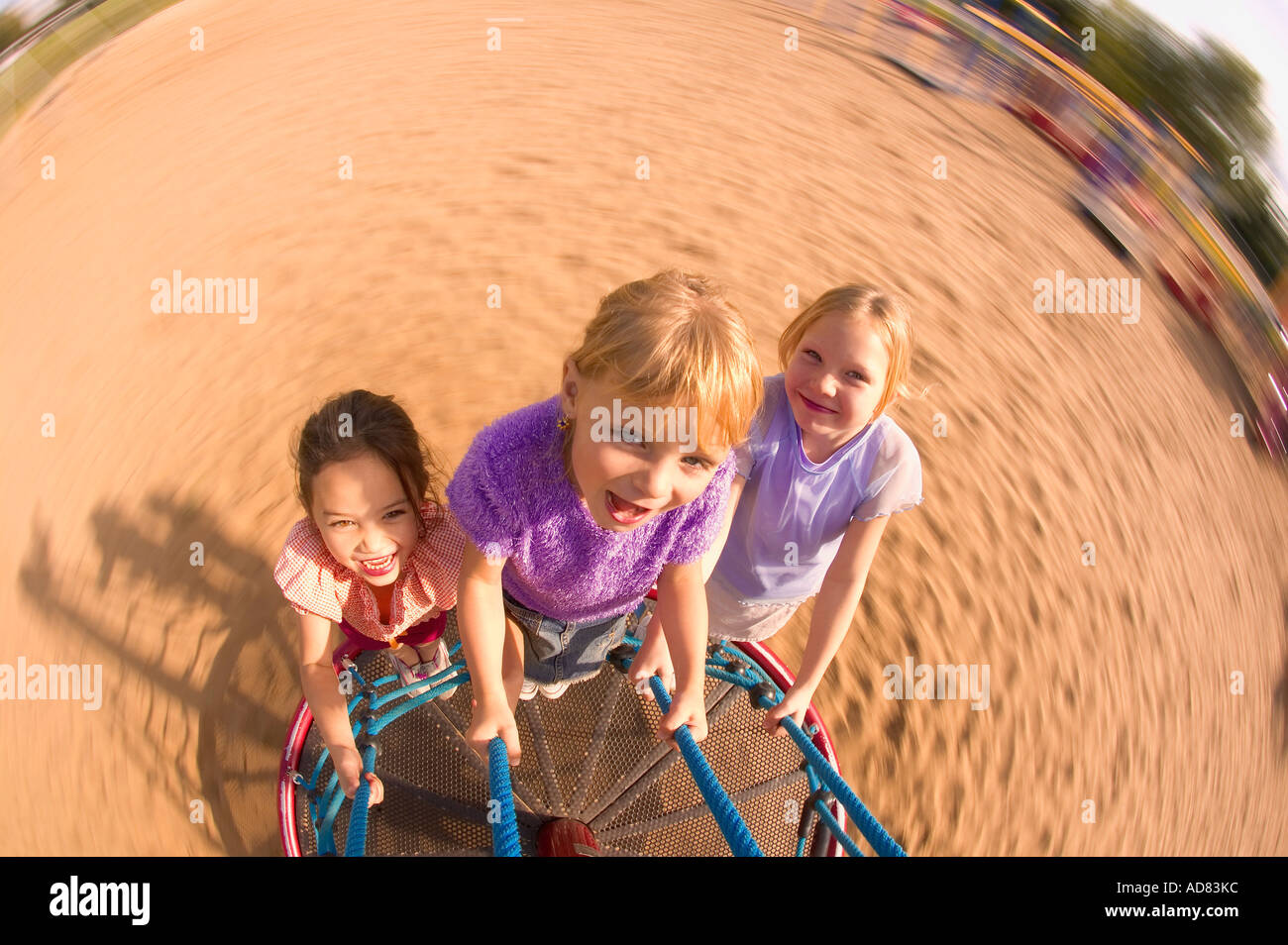 Children spinning on playground Stock Photo - Alamy