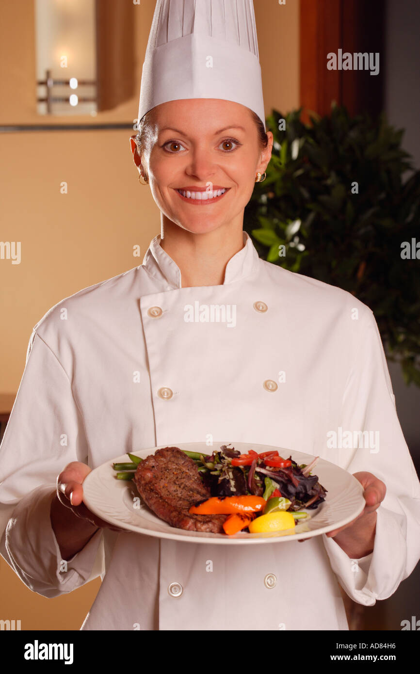 Chef showing off her plate of food Stock Photo - Alamy
