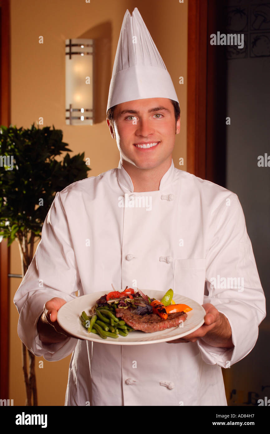 Chef showing off plate of food Stock Photo - Alamy