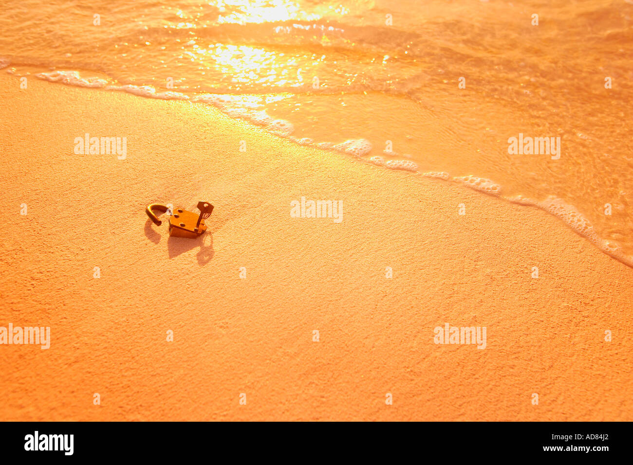 Lock and key on a beach Stock Photo - Alamy