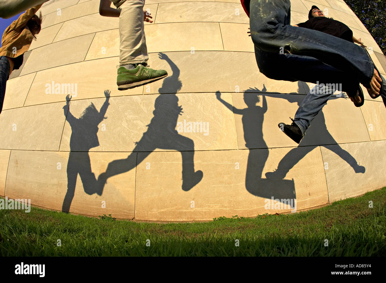 four young adults leaping with their shadows on the wall lifestyle 12 ...