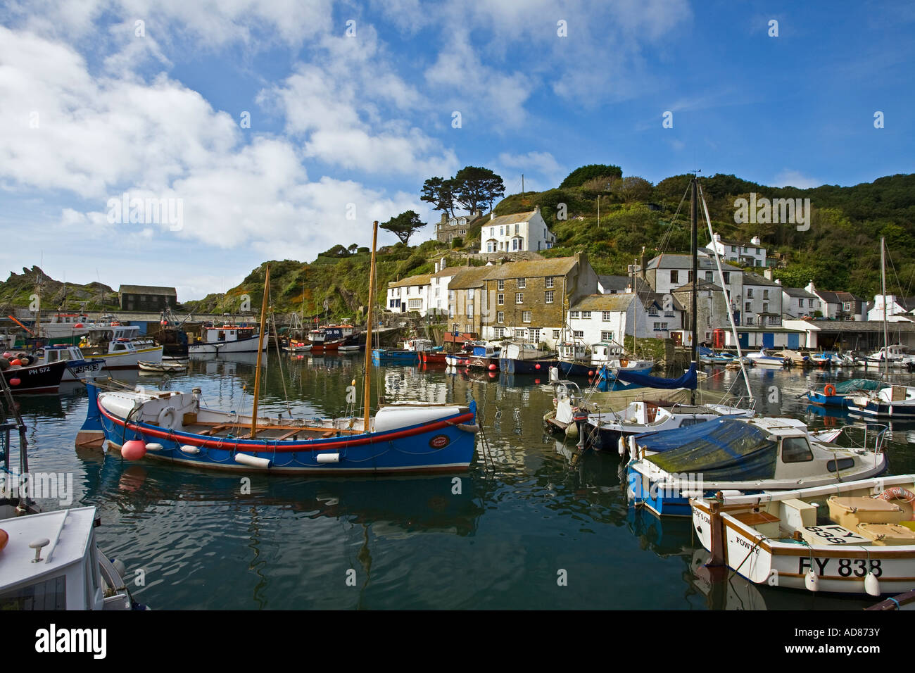 Polperro harbour with an old lifeboat moored centrally Stock Photo - Alamy