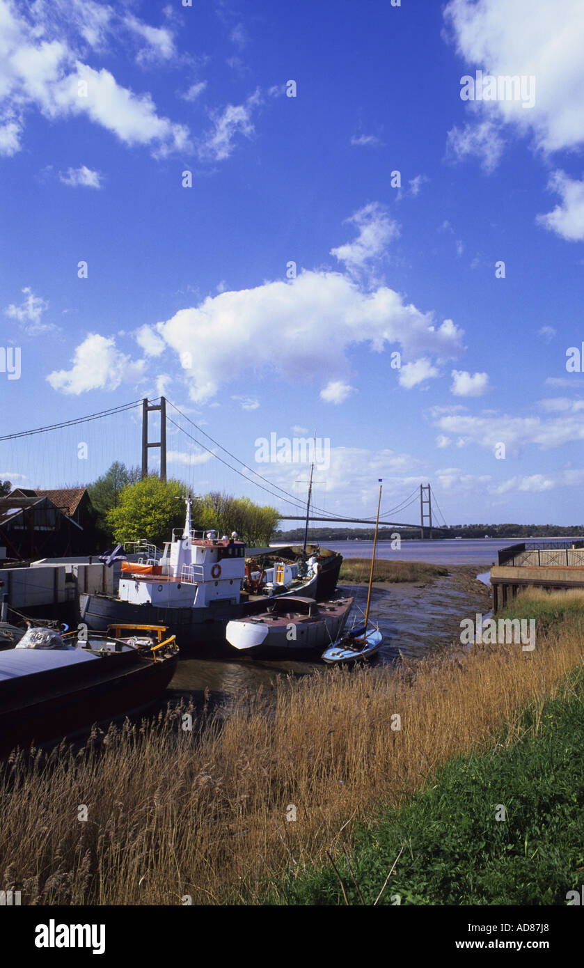 boats moored on the humber estuary with the humber bridge behind ...