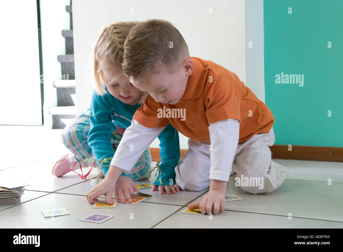 Brother and sister are playing with cards Stock Photo - Alamy