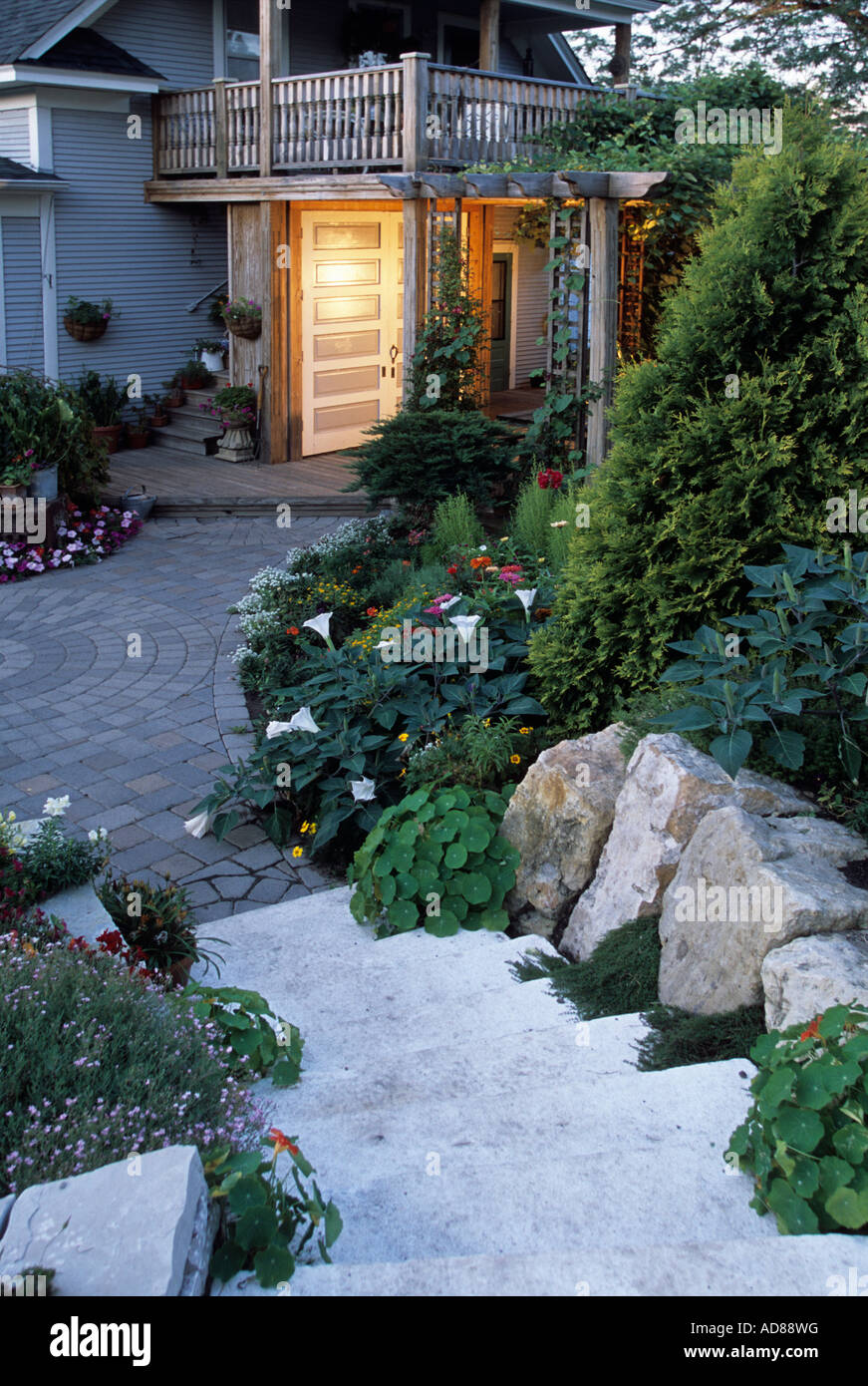 WALKWAY OF BORGERT PAVERS, DATURA AND BOULDER-LINED STEPS LEAD TO ST ...