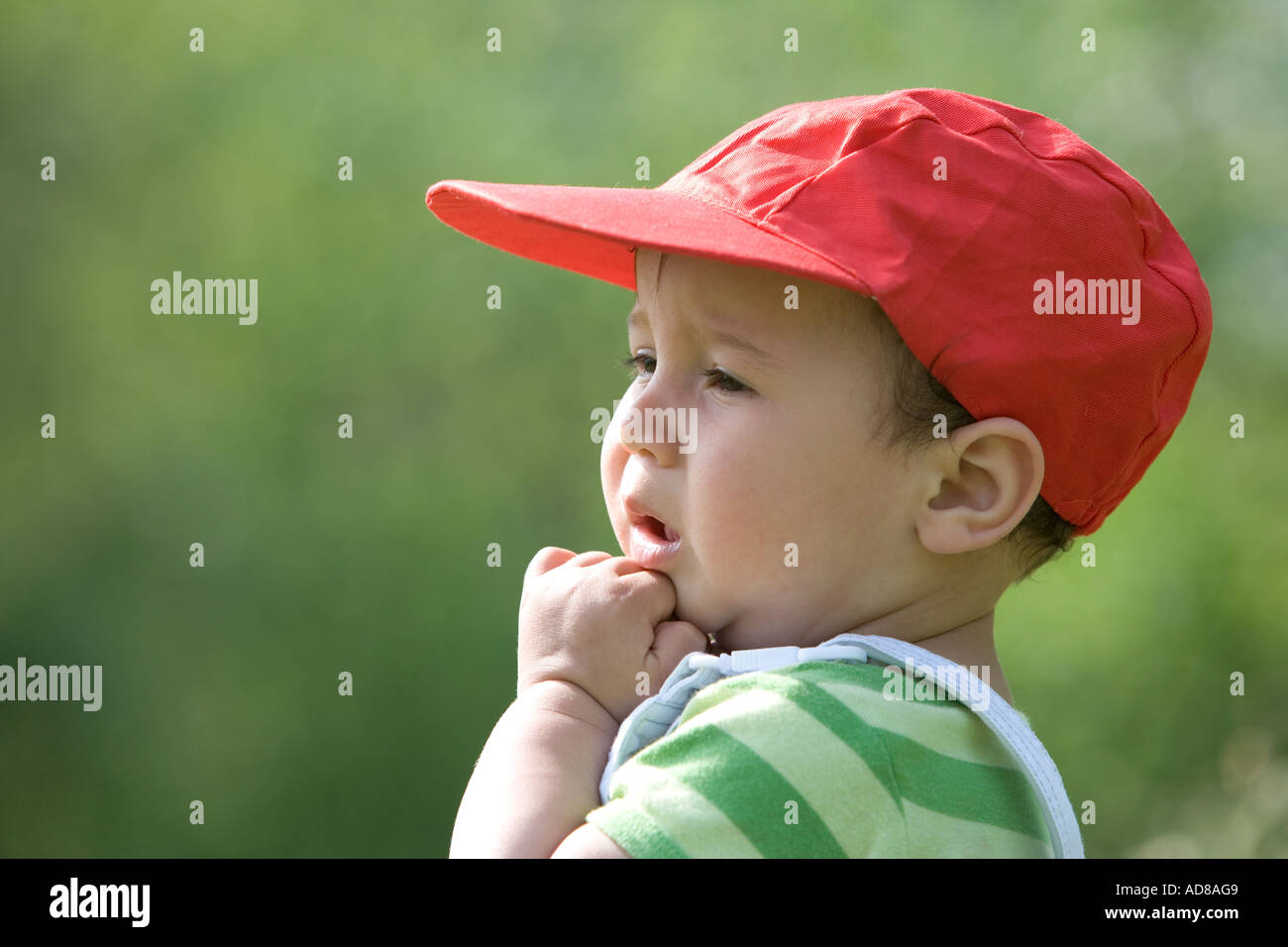 Toddler with a red cap outside Stock Photo - Alamy