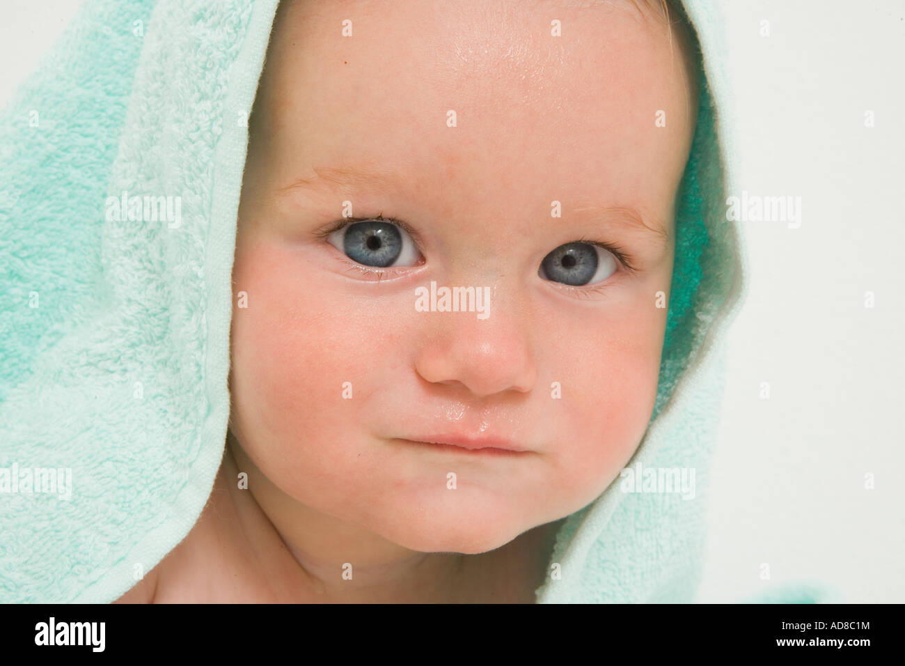 Baby with blue towel over her head Stock Photo - Alamy