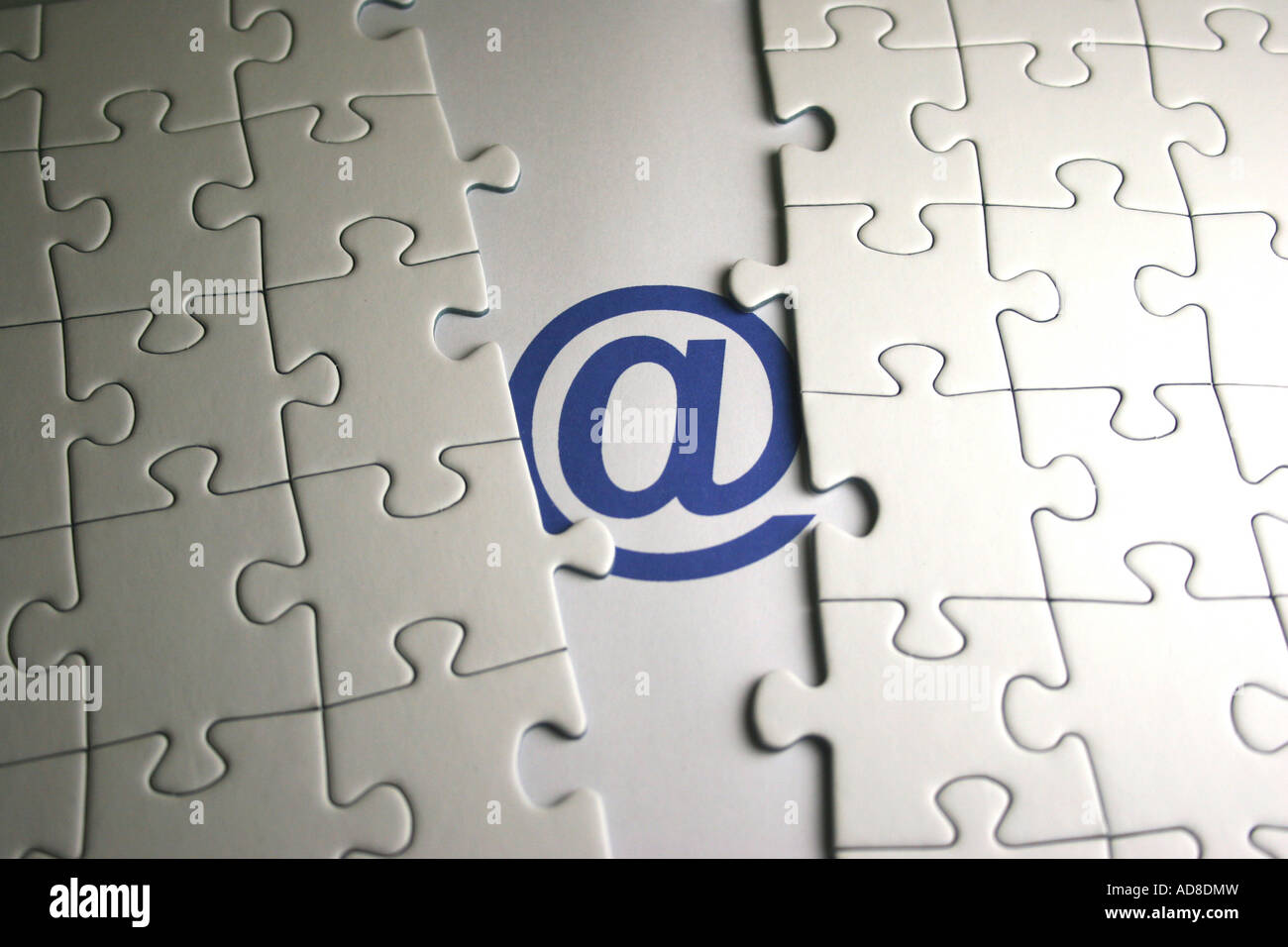 jigsaw and at sign Stock Photo - Alamy