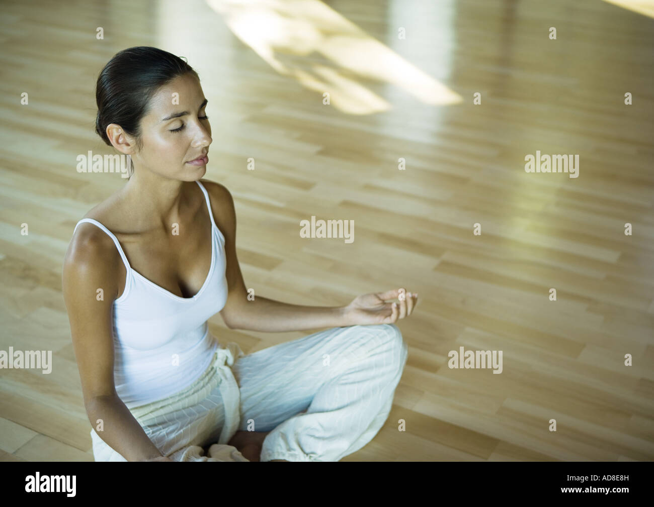 Woman sitting in lotus position with eyes closed Stock Photo - Alamy