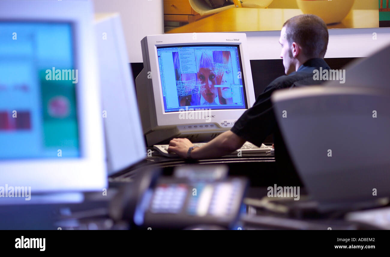 Man using a Macintosh computer to digitally alter photographs Stock ...
