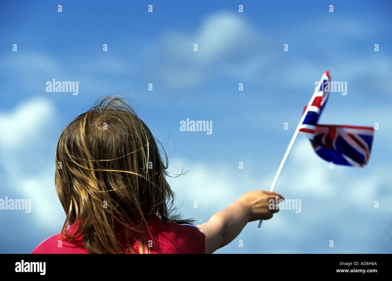 Young girl waving Union Jack flag at a village fate, Leiston, Suffolk ...