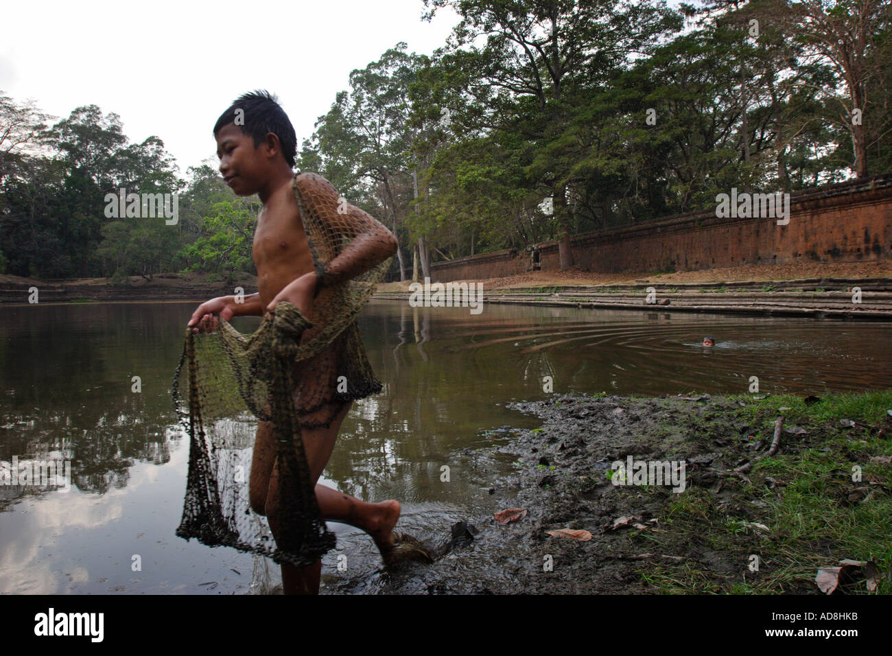 Young boys fishing around the temples of Angkor in Cambodia Stock Photo ...