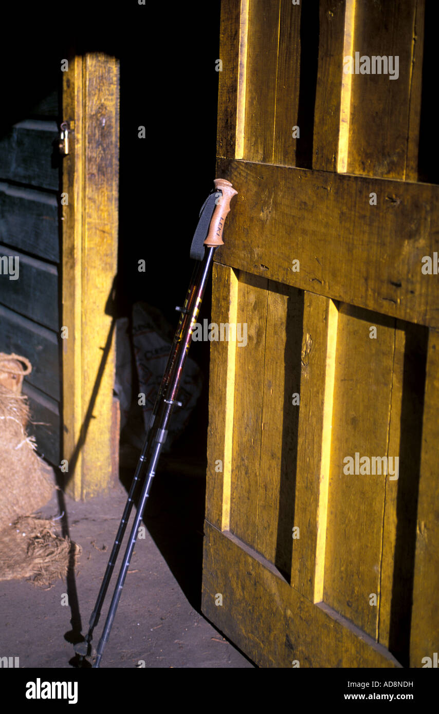 Walking hiking stick leaning againt yellow door outdoor recreation ...