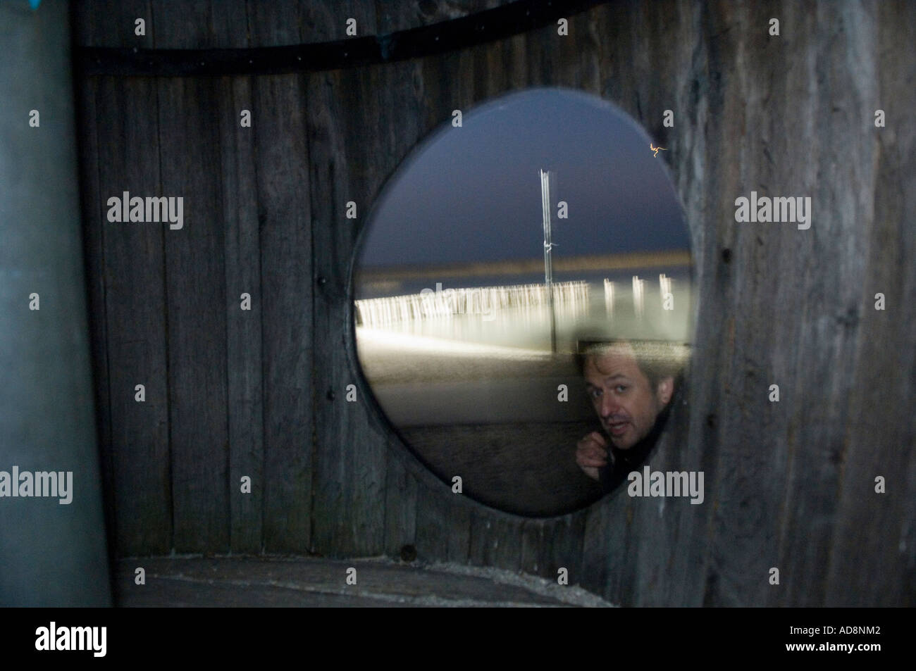 man looking through a round openning Stock Photo - Alamy