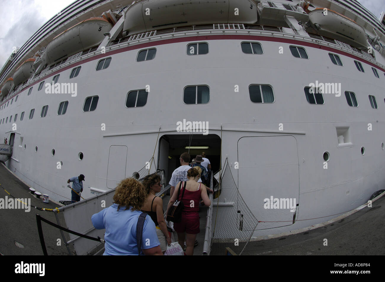 Passengers entering Carnival Cruise ship at dock Havensight harbor ...