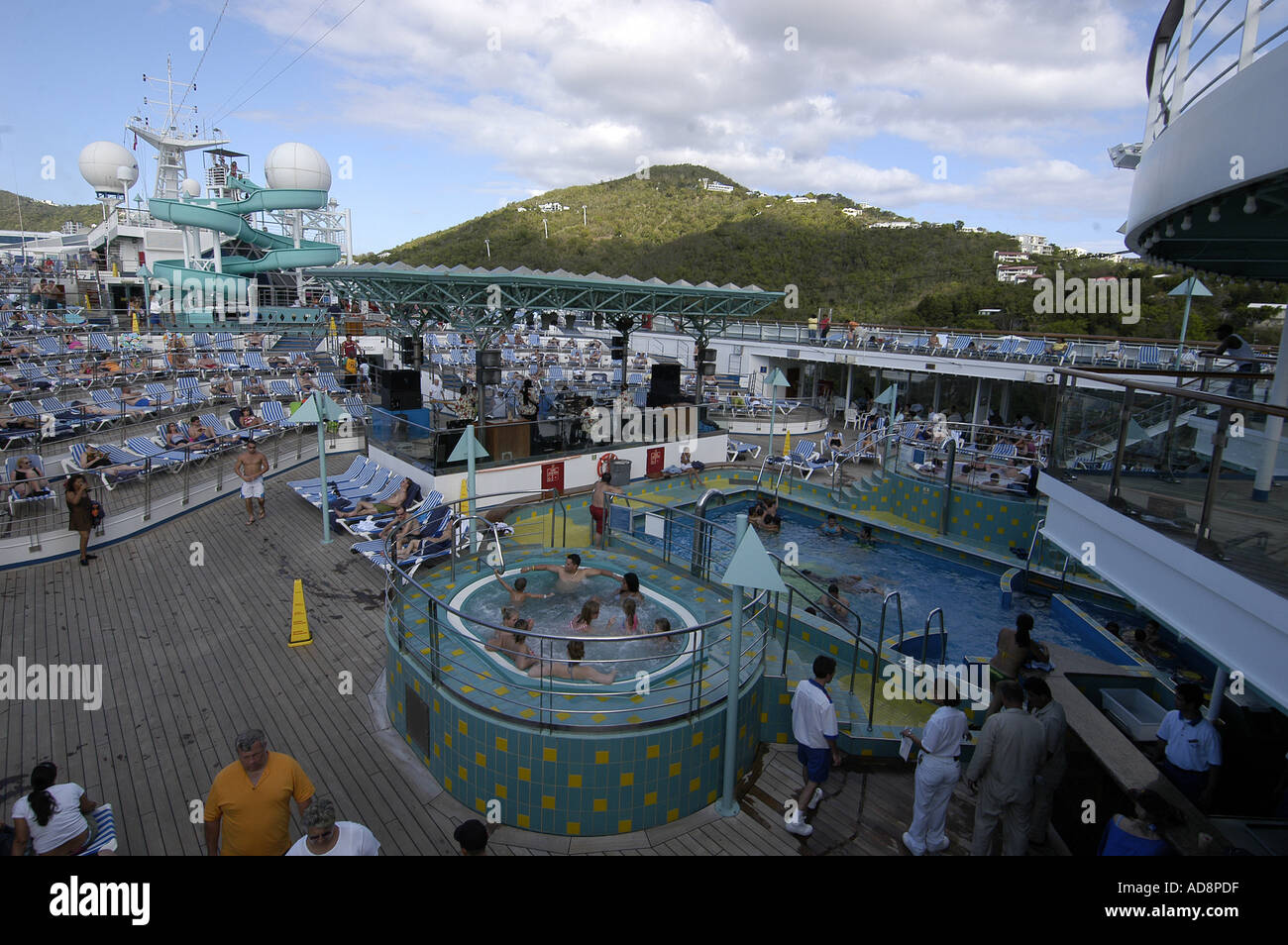 Tourist sunbathing on a hammock on a cruise deck Sailing boats anchored ...