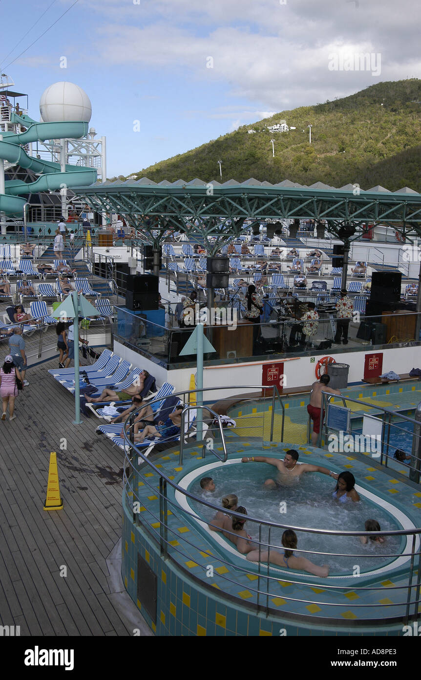 Tourist sunbathing on a hammock on a cruise deck Sailing boats anchored ...