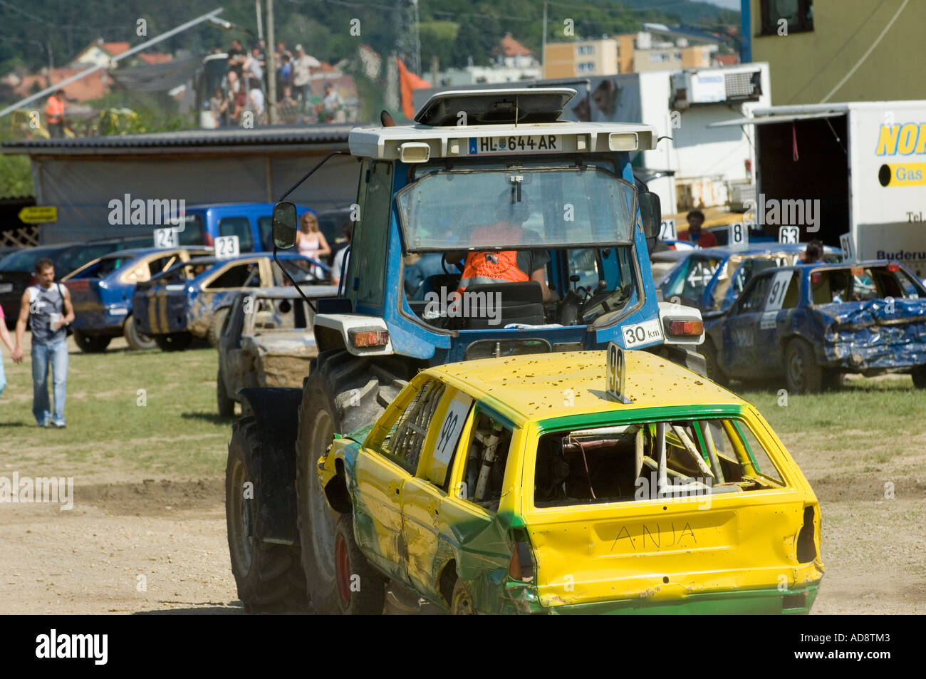 gymkhana car crash race, tractor towing a racing car Stock Photo - Alamy