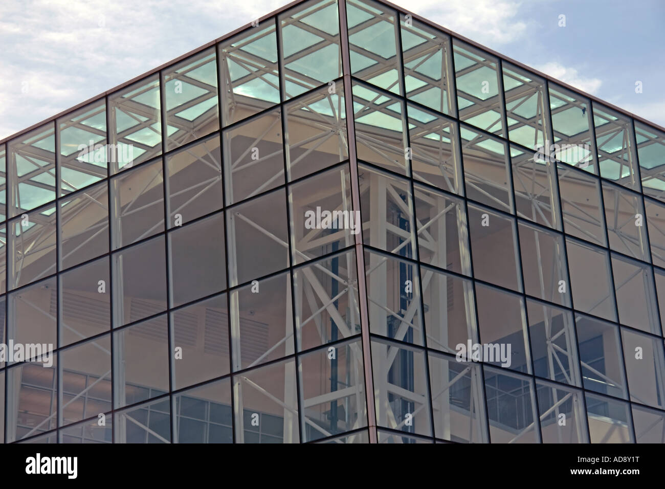 A close view of a leaning glass facade on a building exhibiting modern ...
